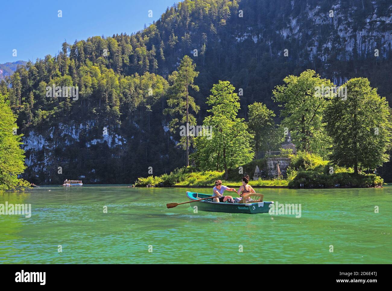 Rowing boat in front of the island Christlieger on the Koenigssee ...