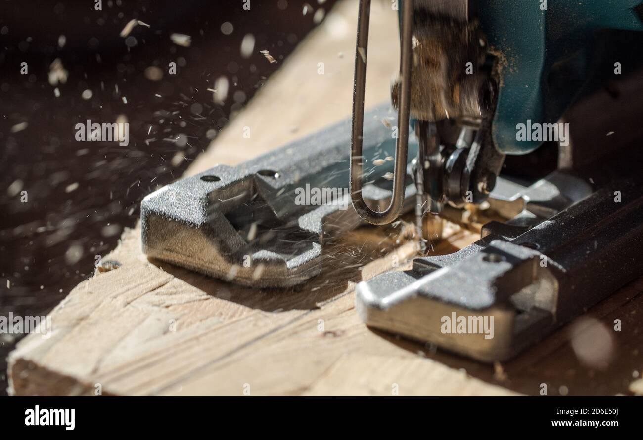 Power jigsaw in operation cutting a wooden board Stock Photo - Alamy