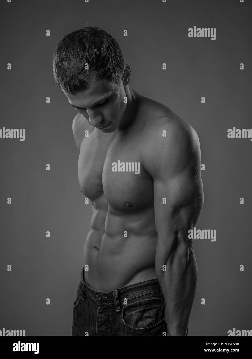 Muscular and fit young man posing shirtless Stock Photo - Alamy