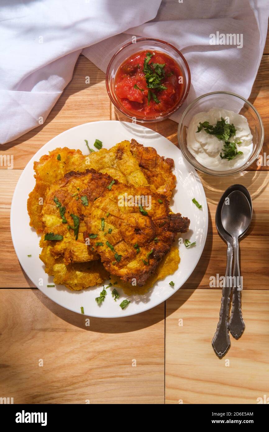 Latin American cuisine fried green plantain tostones with tomato salsa ...