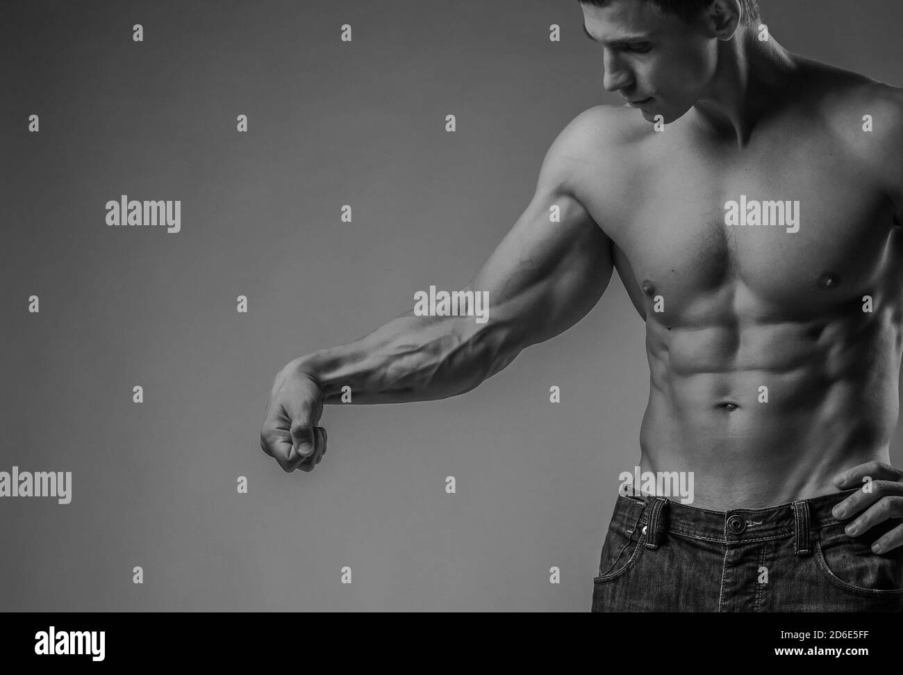 Muscular arm and torso of a perfectly fit young man Stock Photo - Alamy