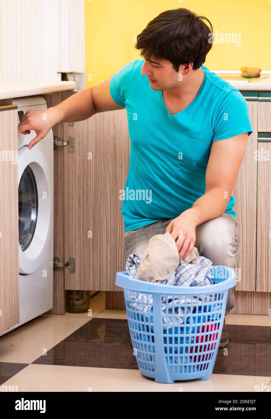 The young husband man doing laundry at home Stock Photo - Alamy