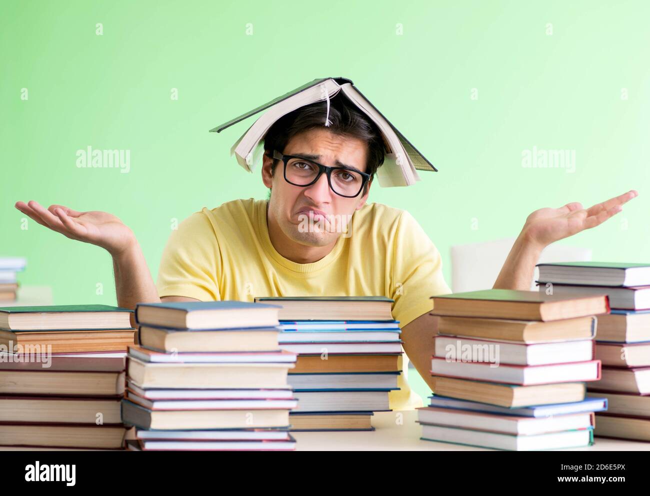 The student with too many books to read before exam Stock Photo - Alamy