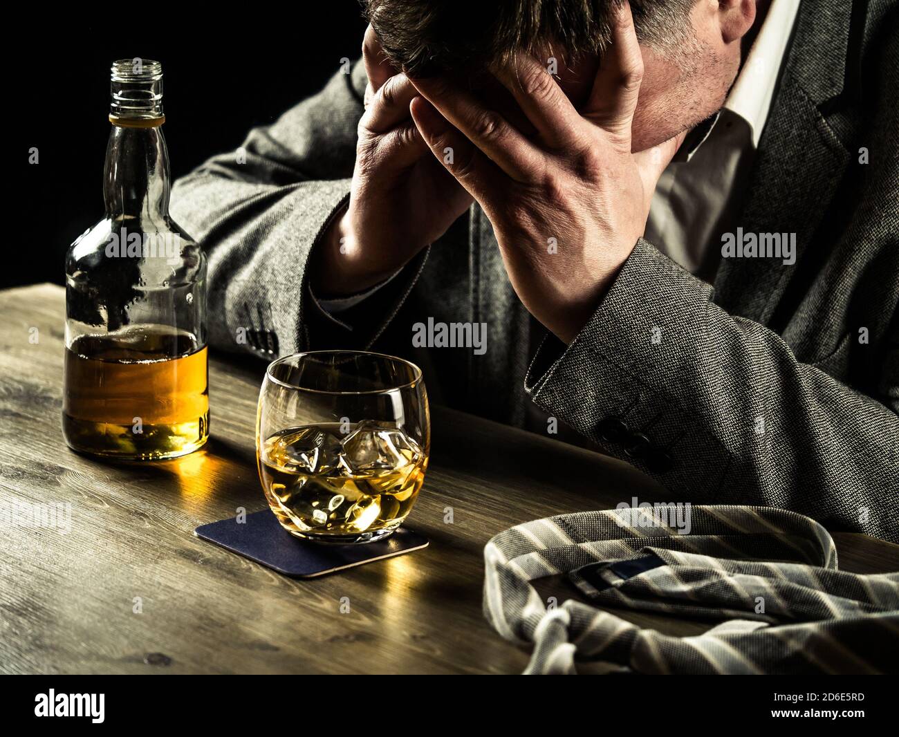 Stressed out businessman drinking whiskey Stock Photo - Alamy