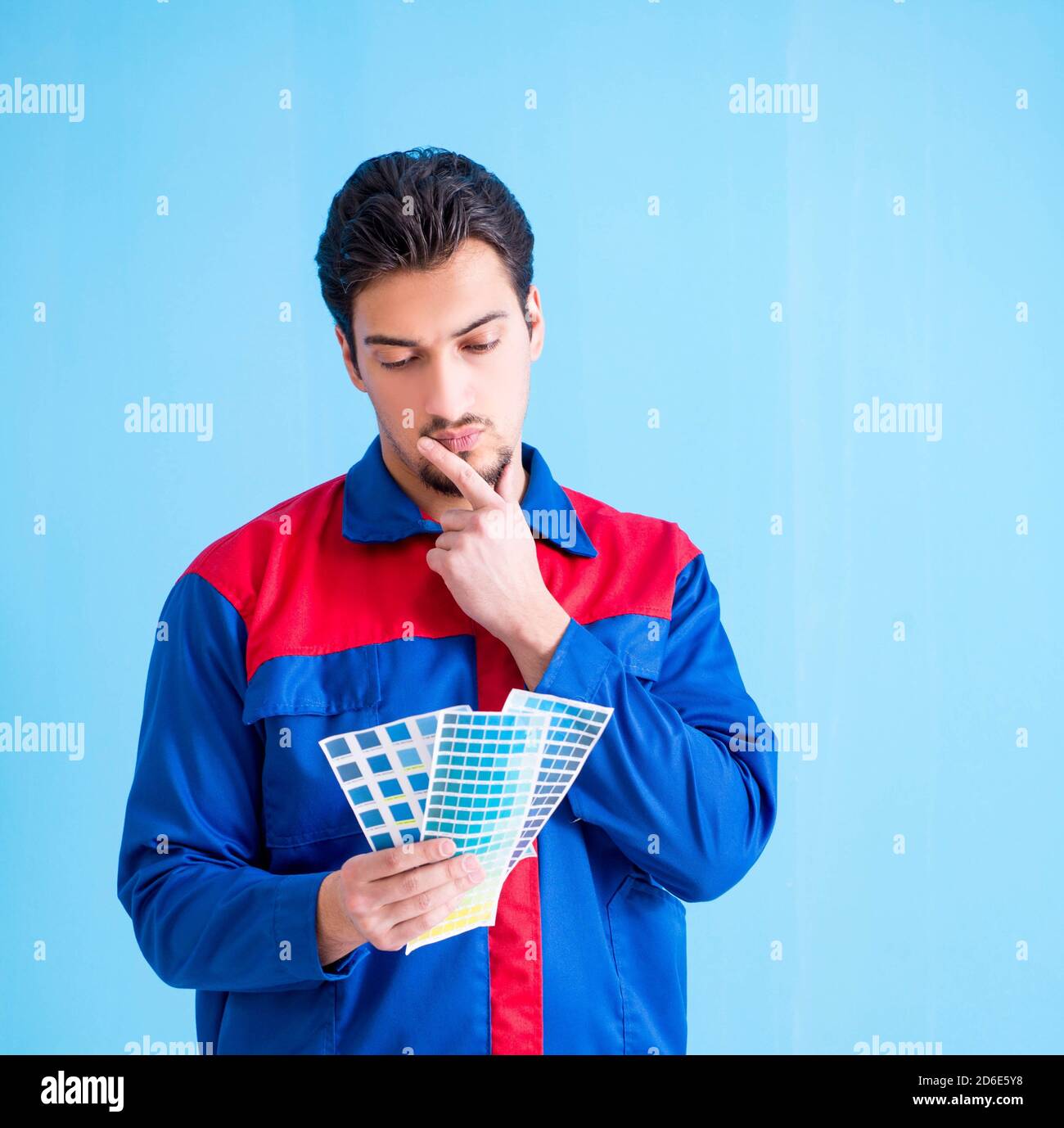 The young man contractor choosing color from rainbow Stock Photo - Alamy