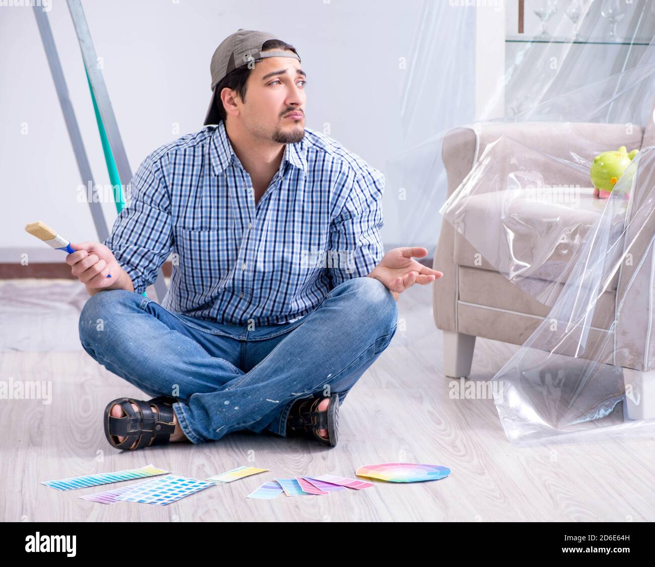 The young man contractor choosing color from rainbow Stock Photo - Alamy