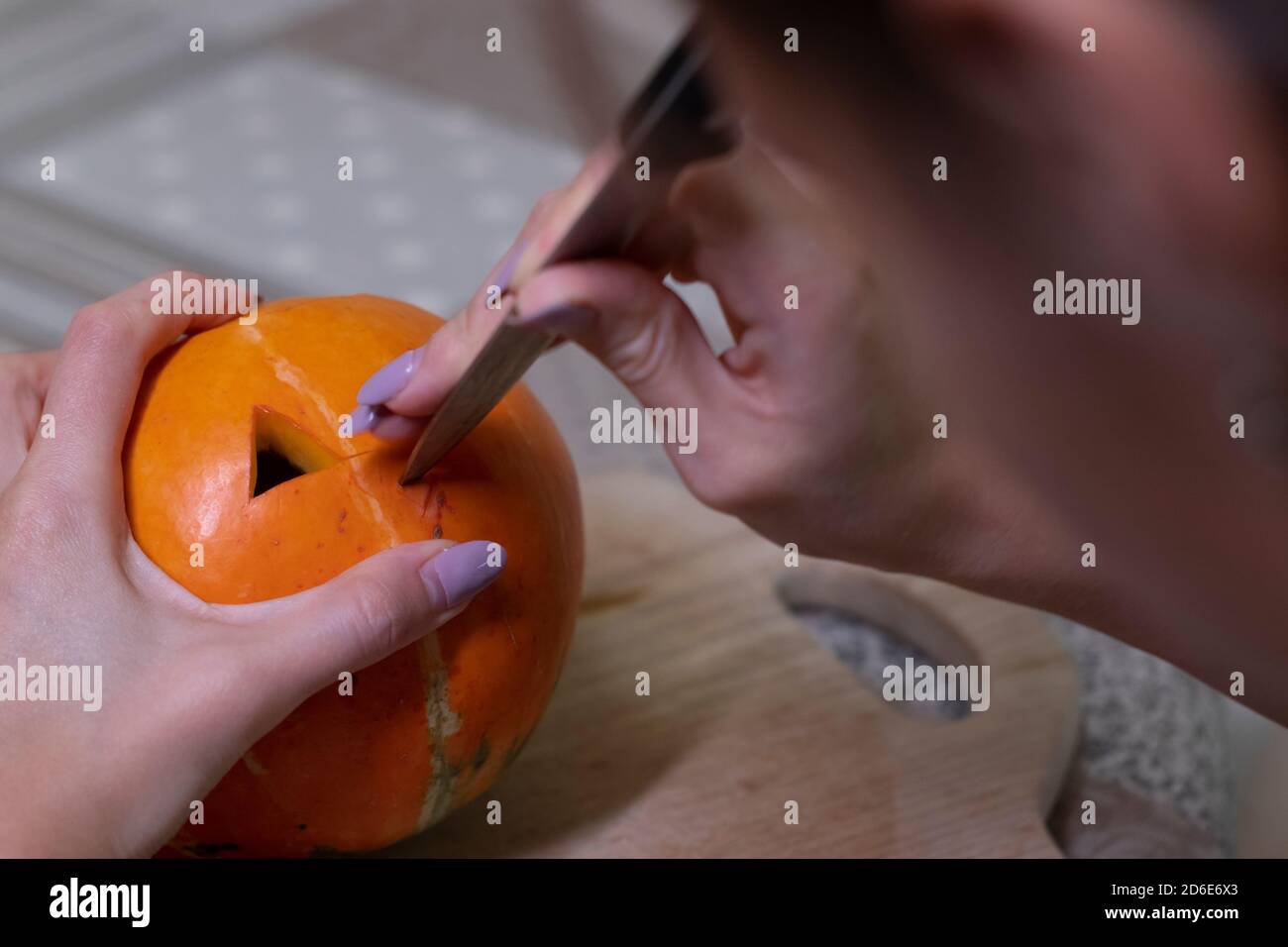 the process of making a Halloween pumpkin. cutting nose. horror theme ...