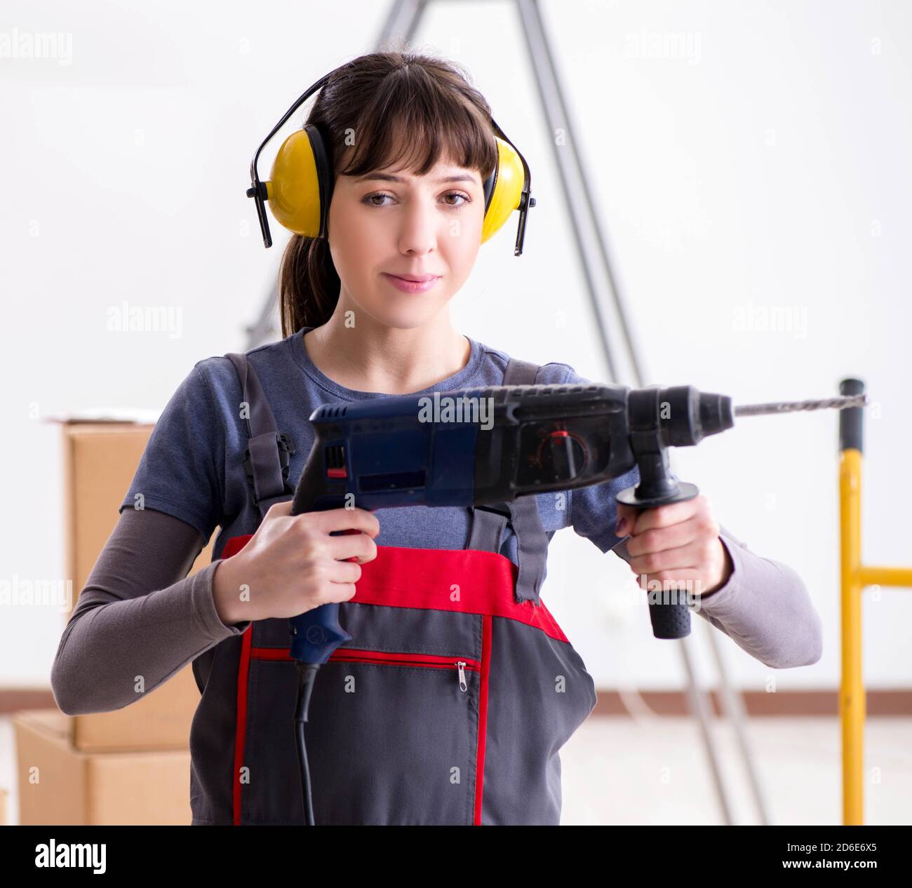 The woman contractor with hand drill at construction site Stock Photo ...