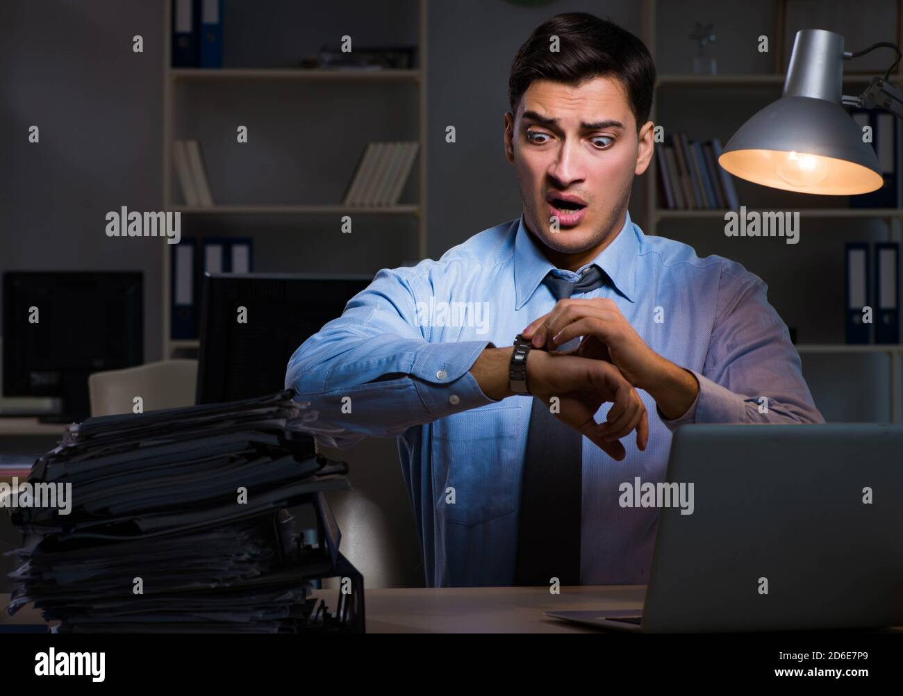 The employee working late at night at important report Stock Photo - Alamy