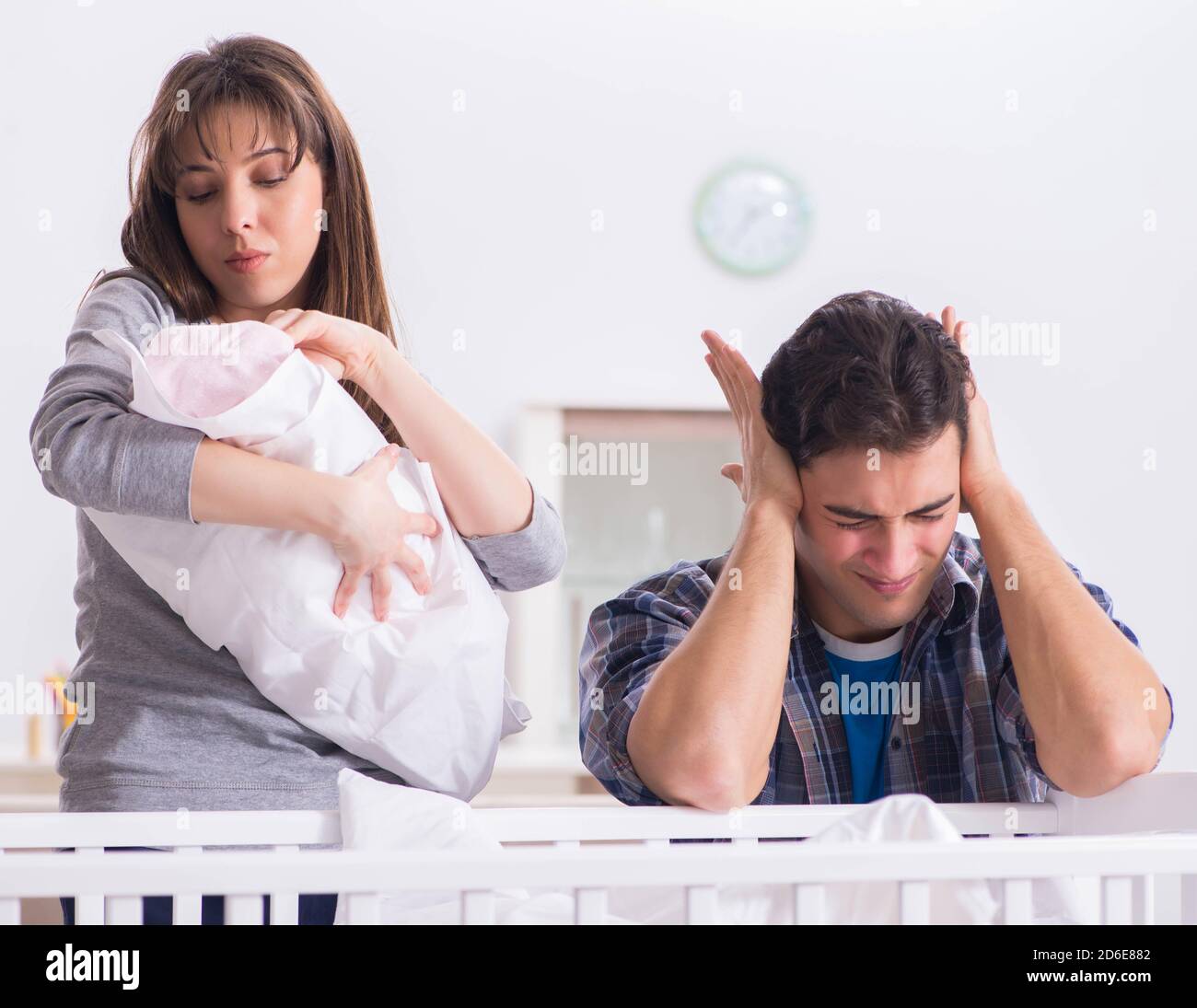 The young dad cannot stand baby crying Stock Photo - Alamy
