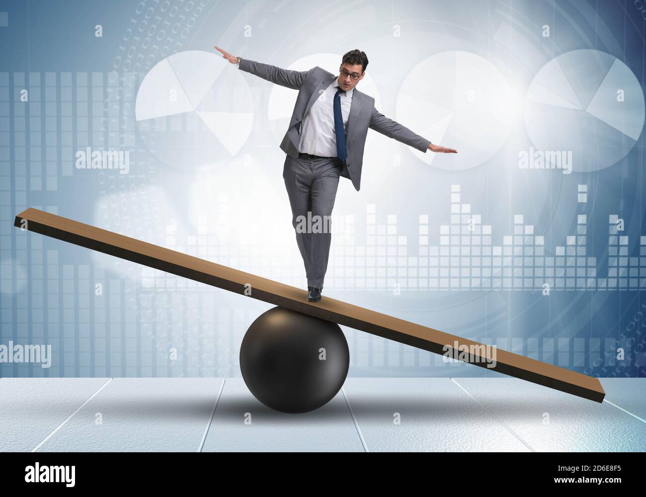 The businessman trying to balance on ball and seesaw Stock Photo - Alamy
