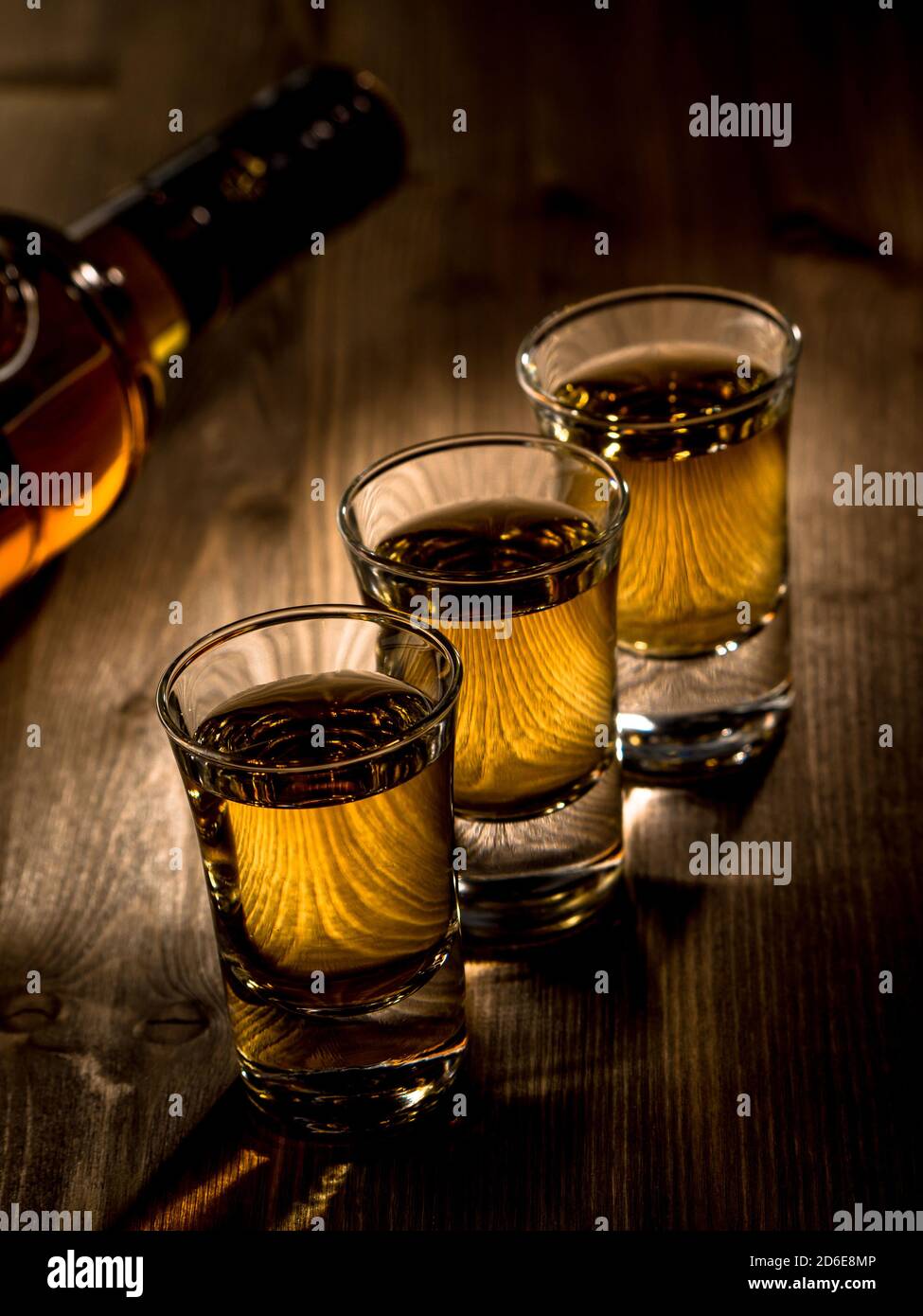 Three shots of whiskey on a bar top Stock Photo - Alamy