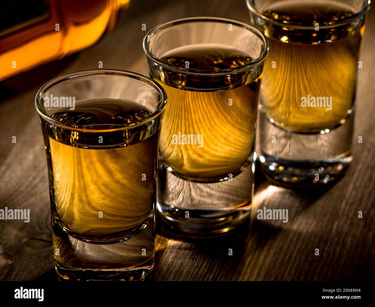 Three shots of whiskey on a bar top Stock Photo - Alamy