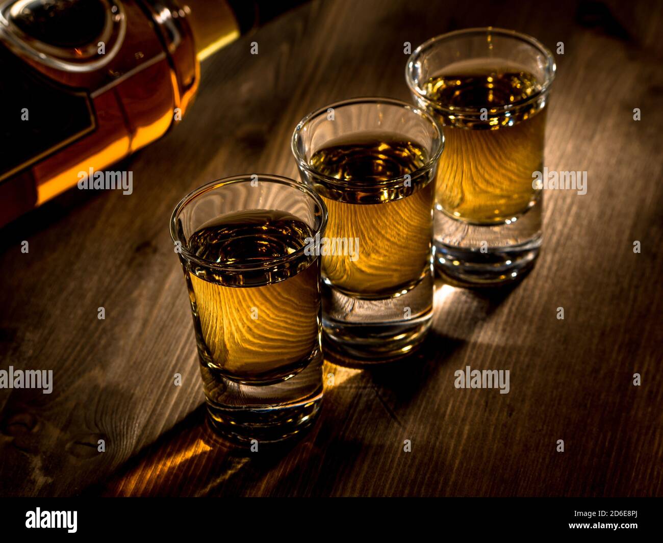 Three shots of whiskey on a bar top Stock Photo - Alamy