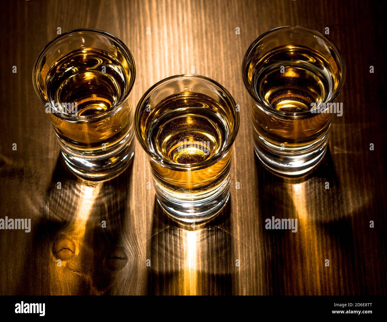 Three shots of whiskey on a bar top Stock Photo - Alamy