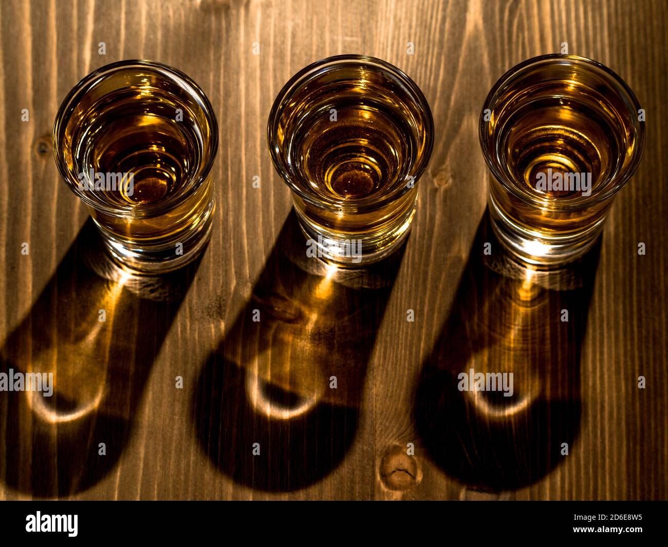 Three shots of whiskey on a bar top Stock Photo - Alamy