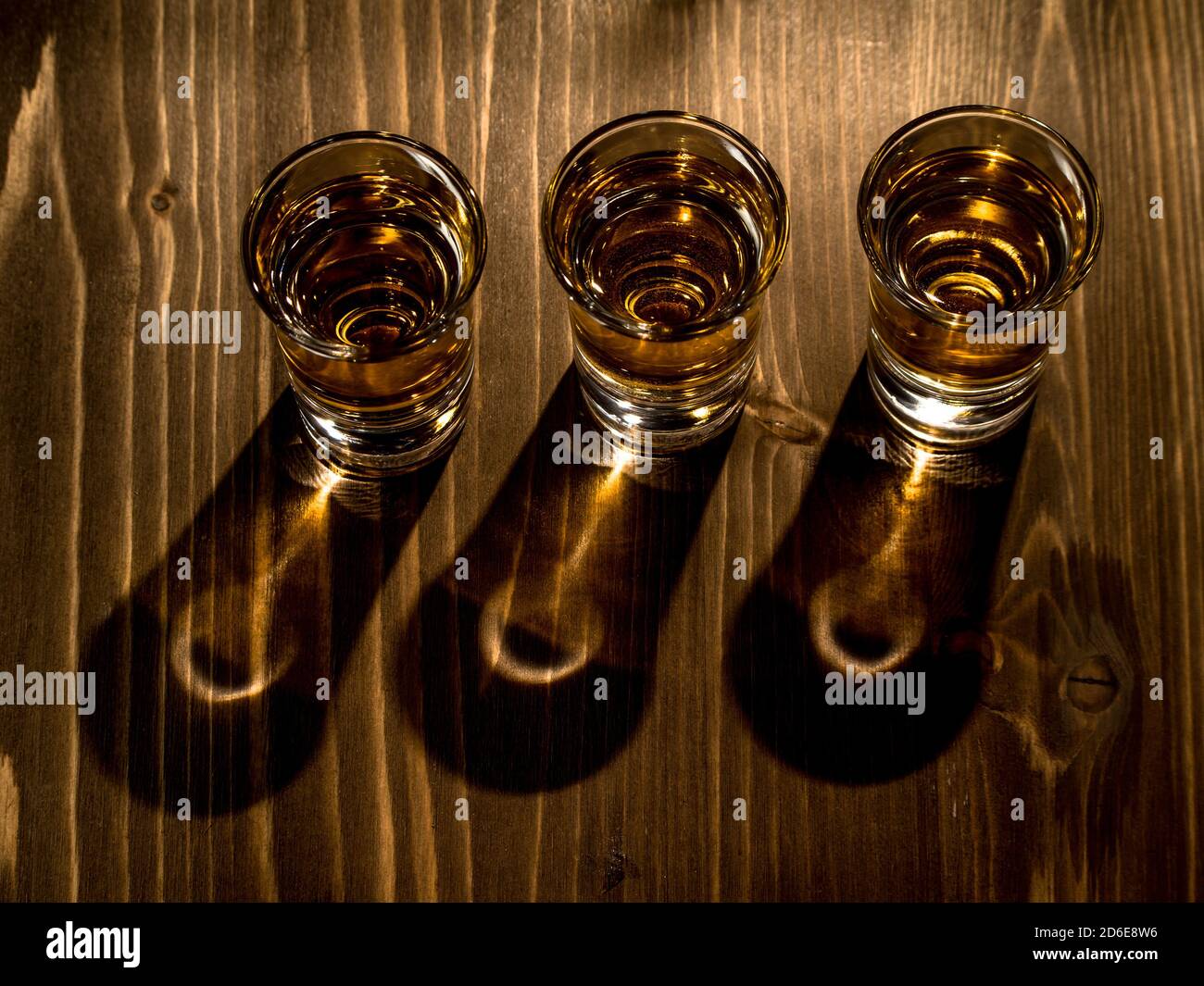 Three shots of whiskey on a bar top Stock Photo - Alamy