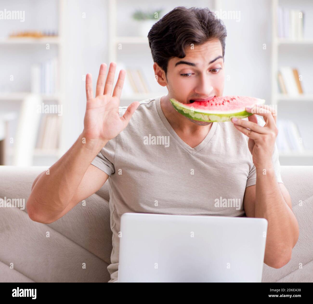 The man eating watermelon at home Stock Photo - Alamy