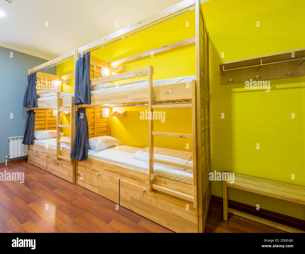 The hostel dormitory beds arranged in room Stock Photo - Alamy