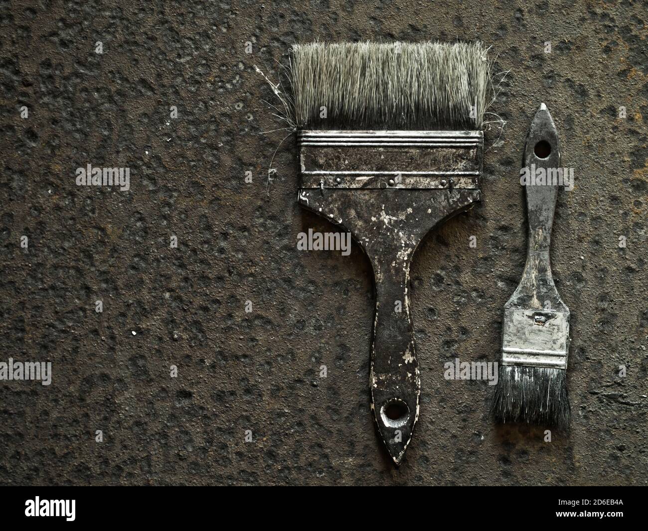 Old brushes over a rusty metal background Stock Photo - Alamy