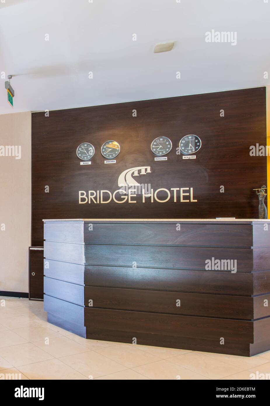 The hotel reception with desk and clocks Stock Photo - Alamy