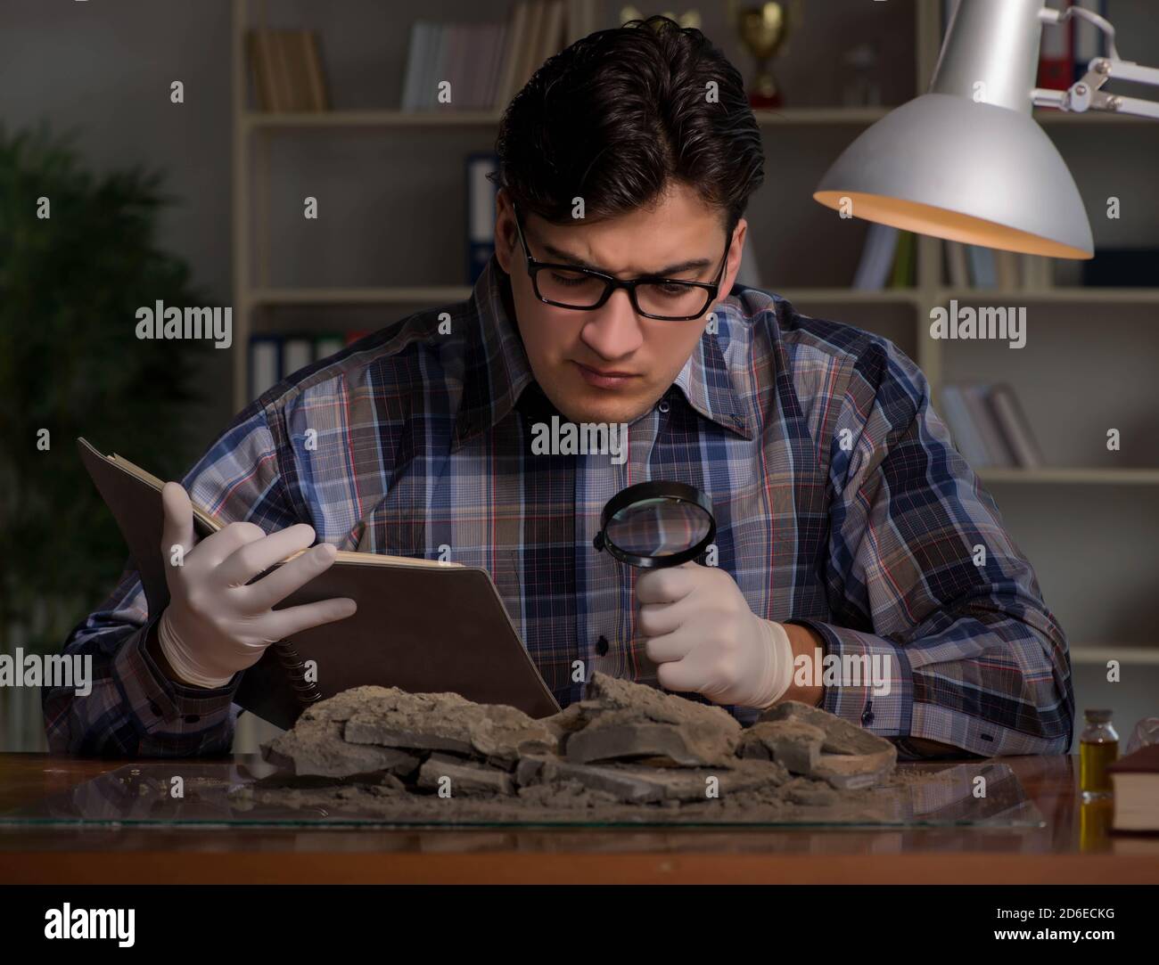The archeologist working late night in office Stock Photo - Alamy
