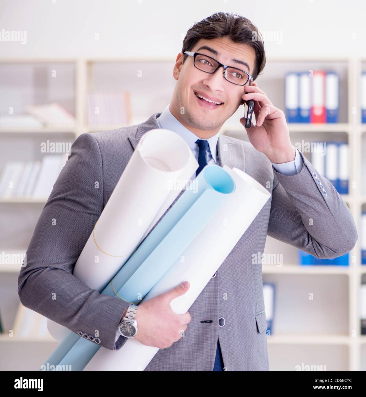 Businessman engineer draftsman with blueprints drawings Stock Photo - Alamy