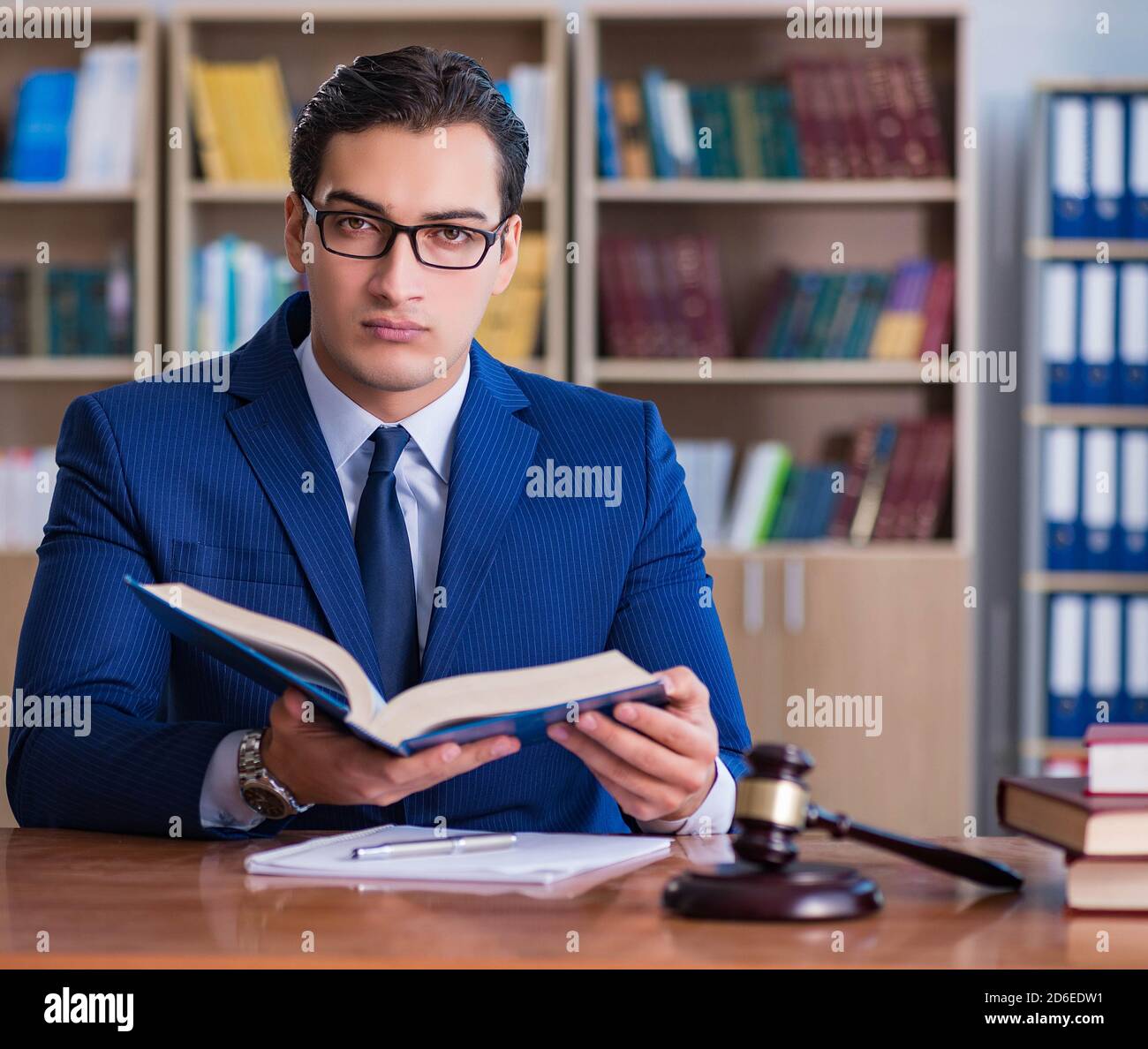 The handsome judge with gavel sitting in courtroom Stock Photo - Alamy