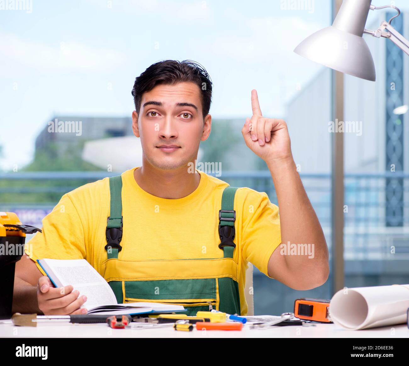 The construction worker sitting at the desk Stock Photo - Alamy