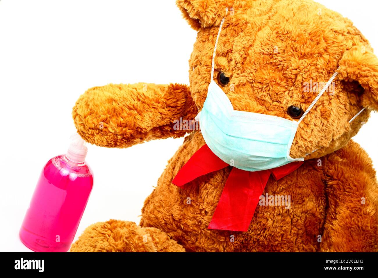 Humorous washing hands concept of a large teddy bear pressing a soap ...