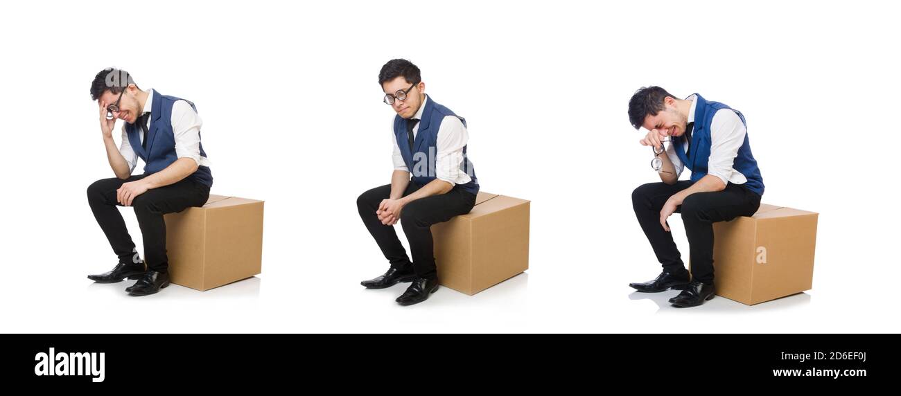 The young employee sitting on the box isolated on white Stock Photo - Alamy