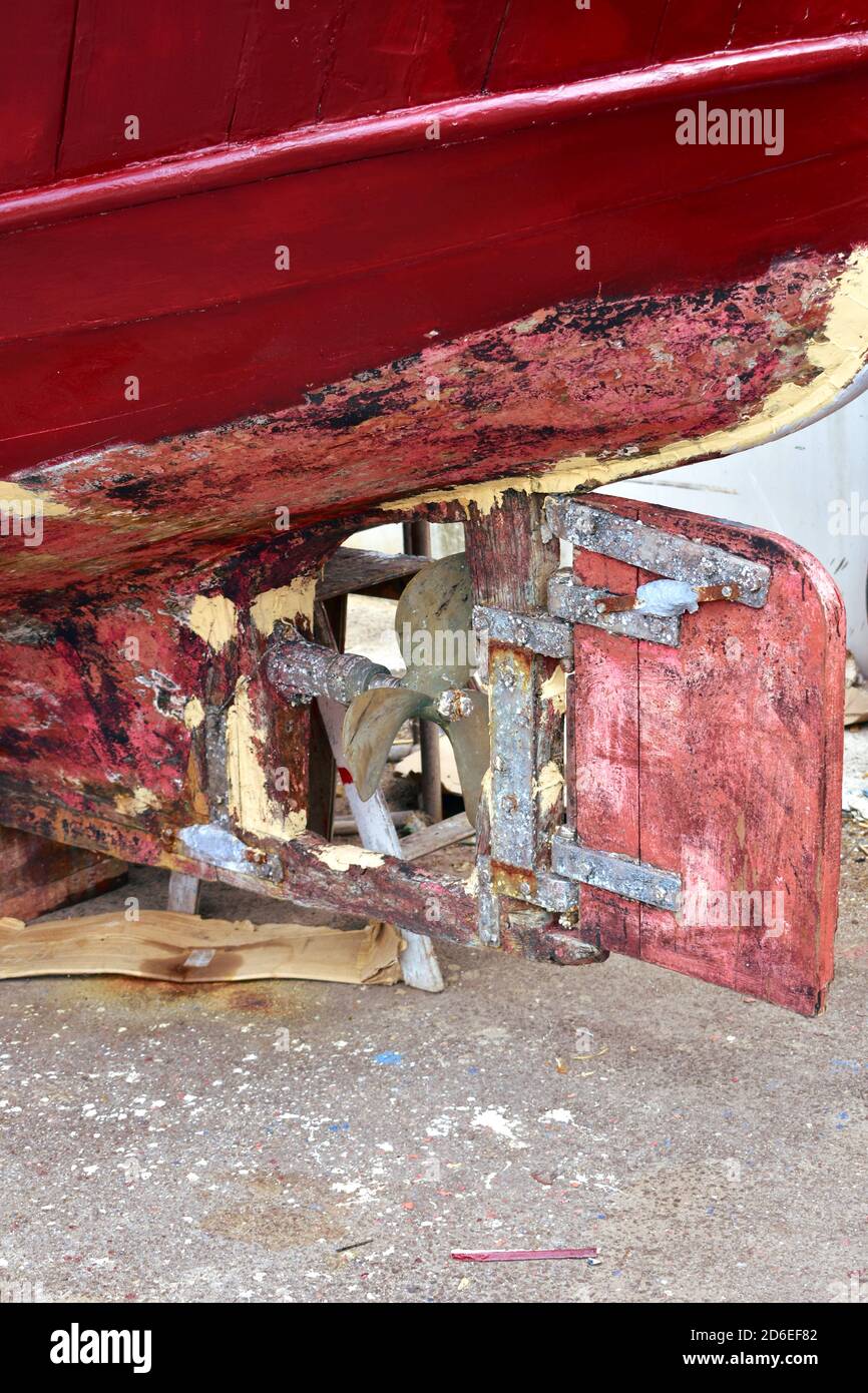 Old red wooden galician fishing vessel in a harbor. Stern, propeller ...