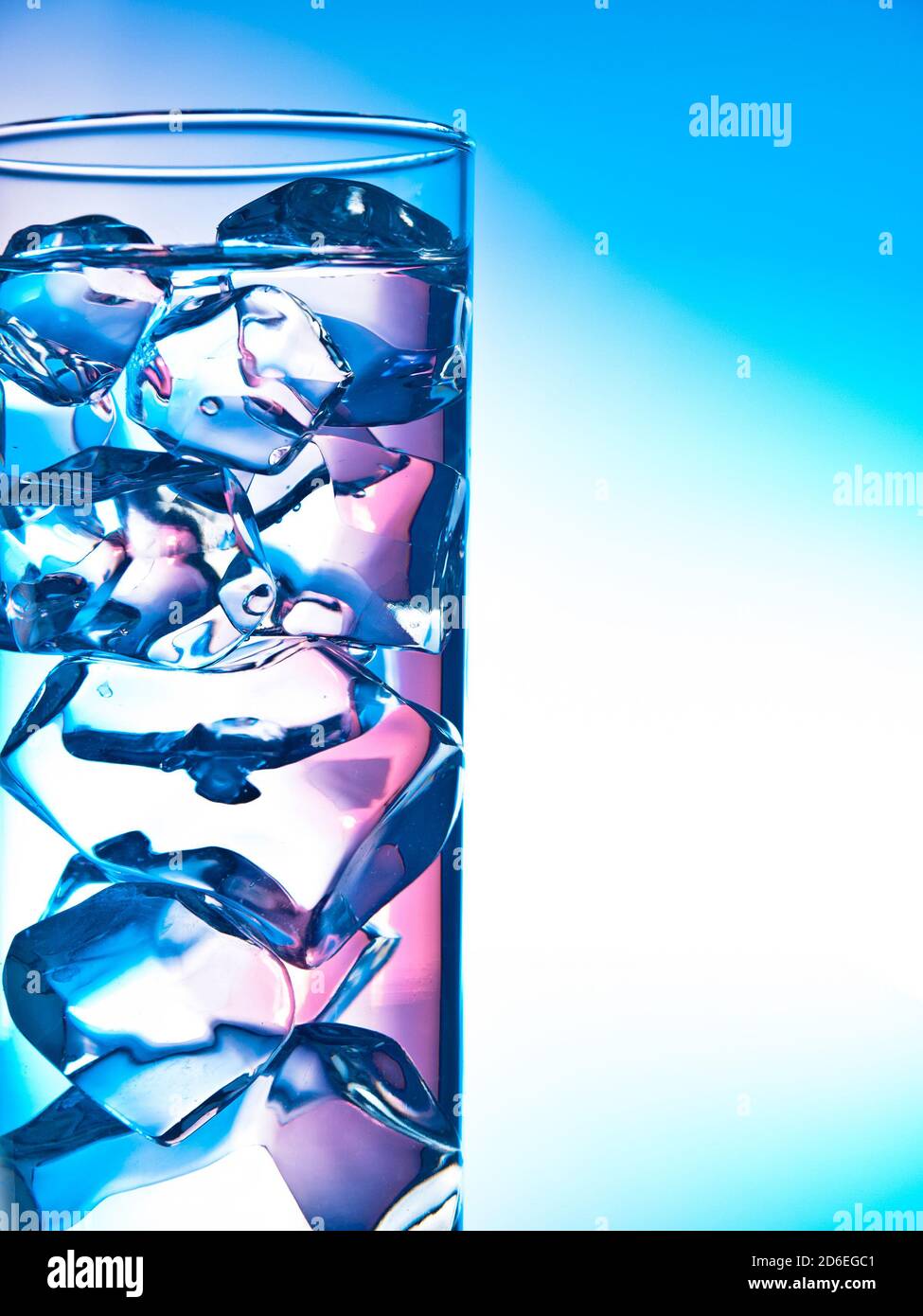 Glass of clear cocktail filled with ice cubes Stock Photo - Alamy