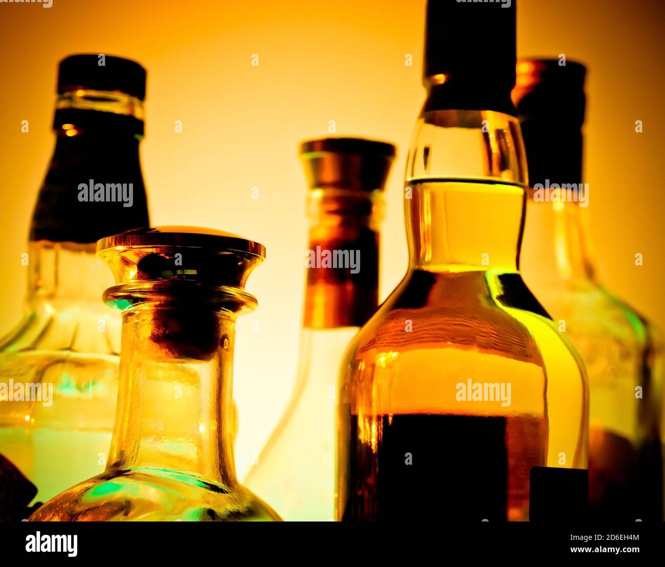 Row of bottles at a bar over yellow background Stock Photo - Alamy