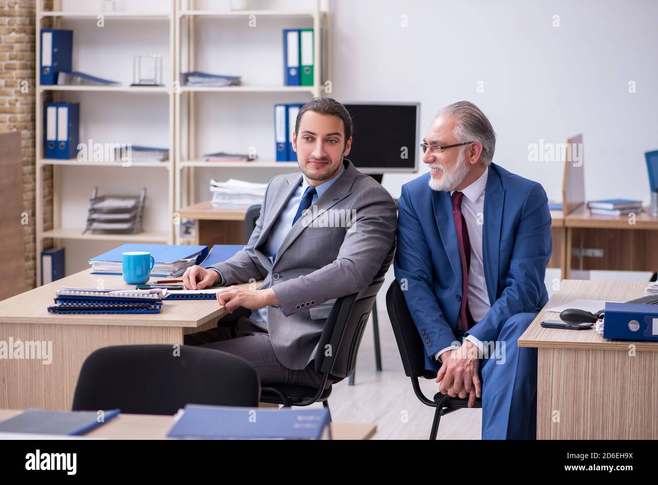Two employees working in the office Stock Photo - Alamy