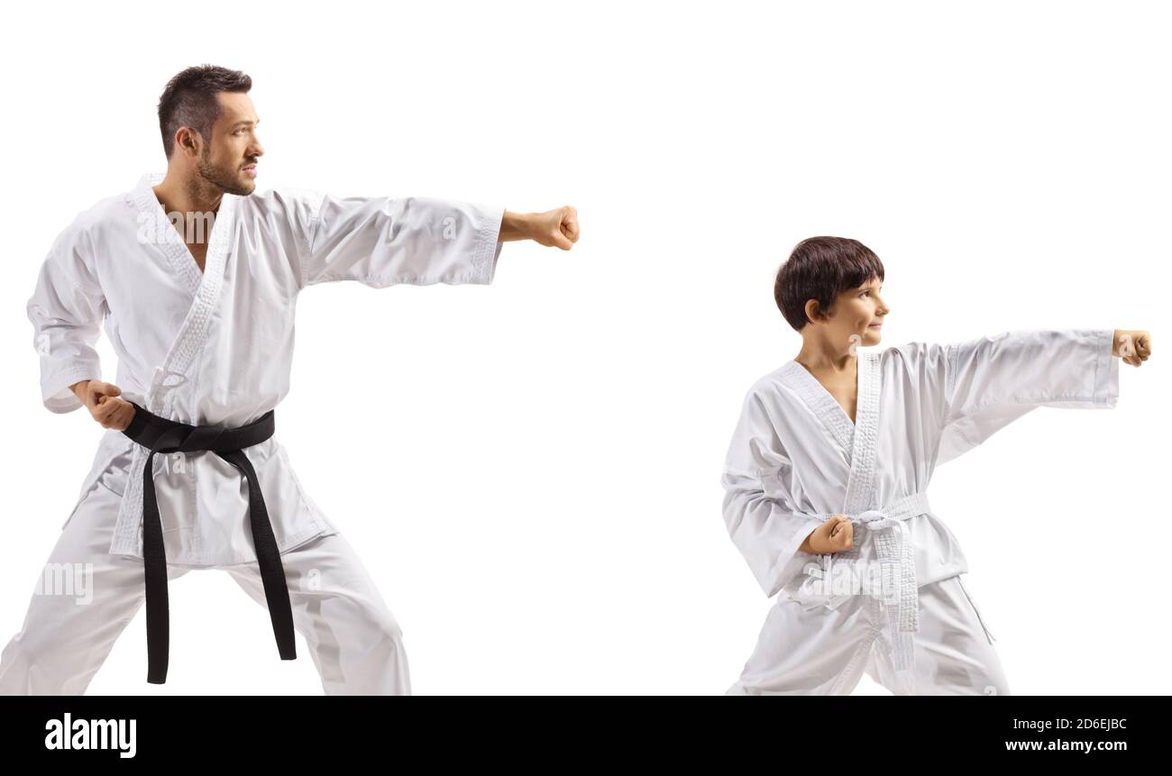 Boy practicing karate with instructor isolated on white background ...