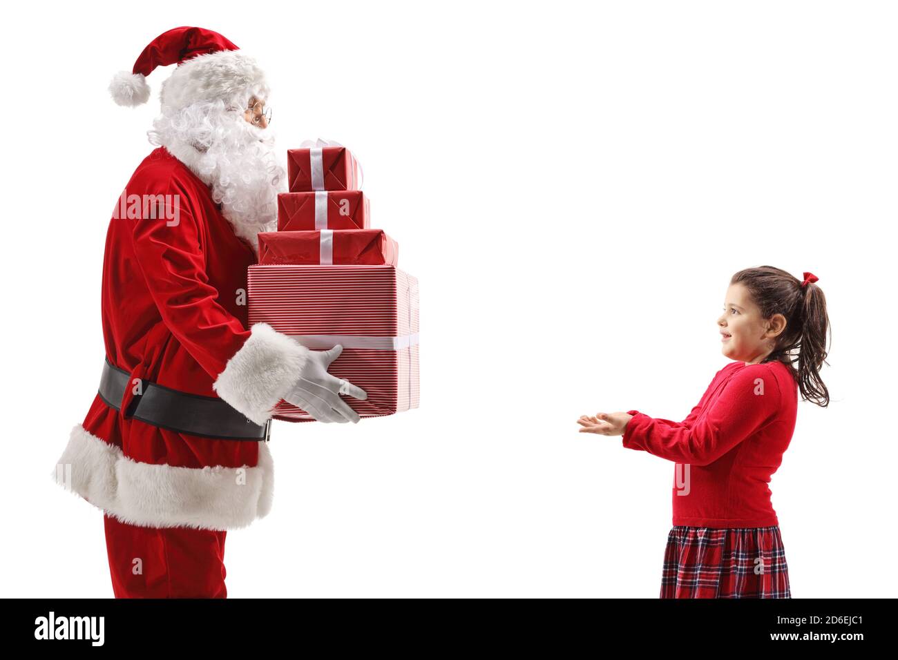 Santa giving presents to a happy little girl isolated on white ...