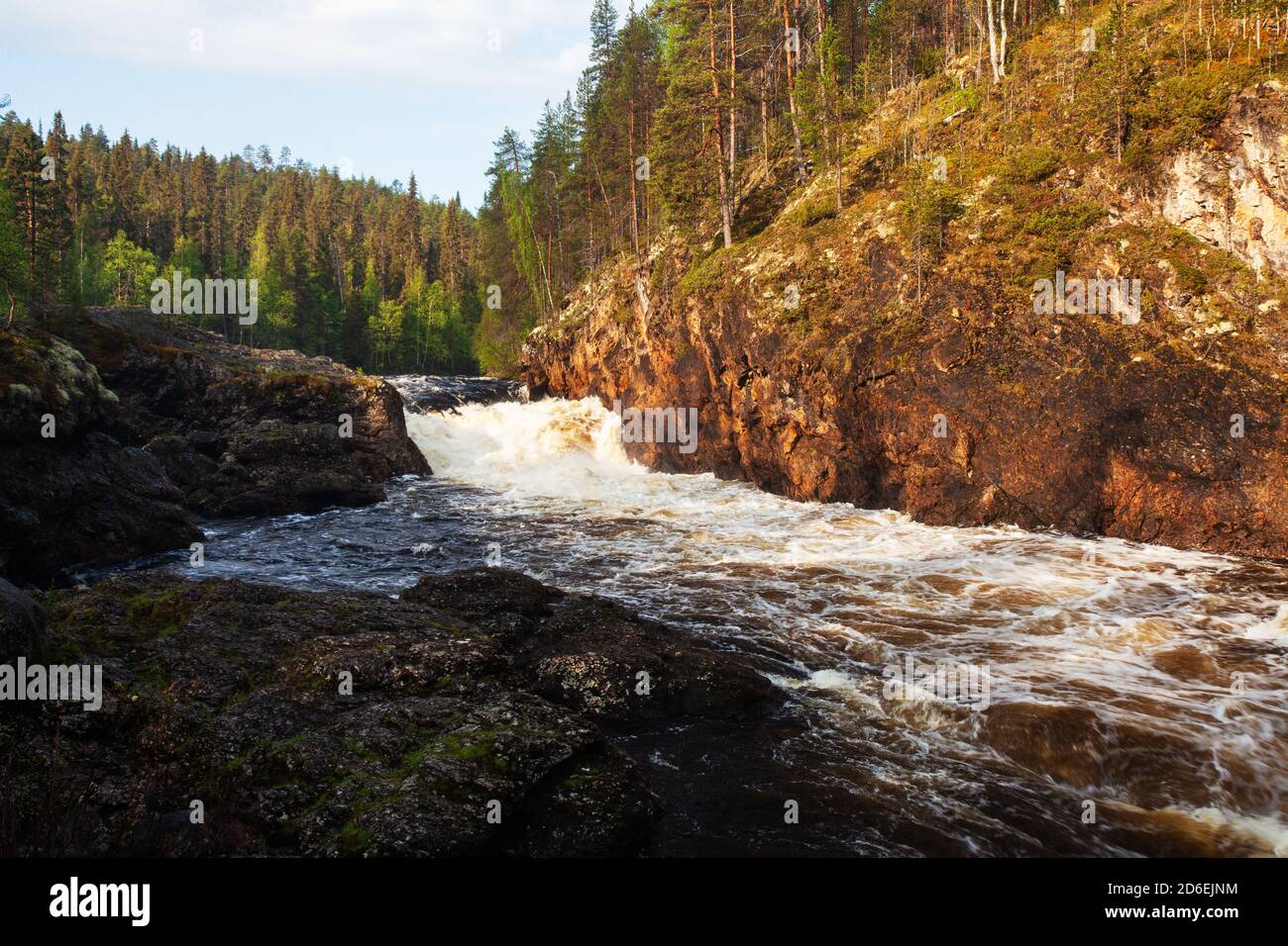 Oulanka National Park. Kiutaköngäs rapids waterfall with red limestone ...