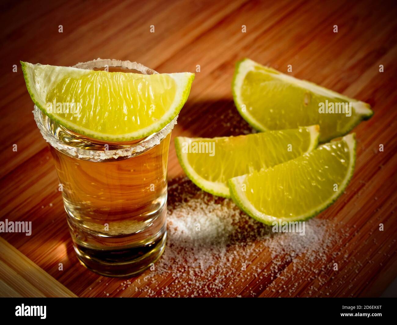 Tequila shot with salt rim and lime wedges Stock Photo - Alamy