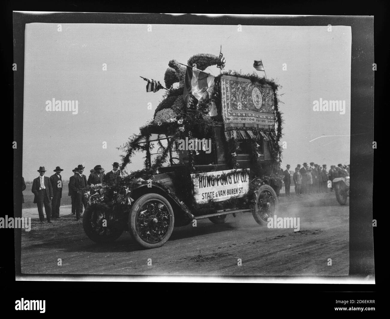 Automobile decorated as float for Hung Fong Lo Co. restaurant during a ...
