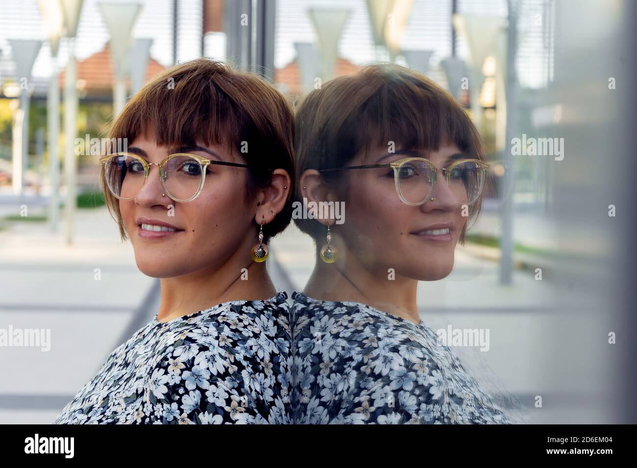 Portrait of a woman. Reflection in glass. Mirror effect Stock Photo - Alamy