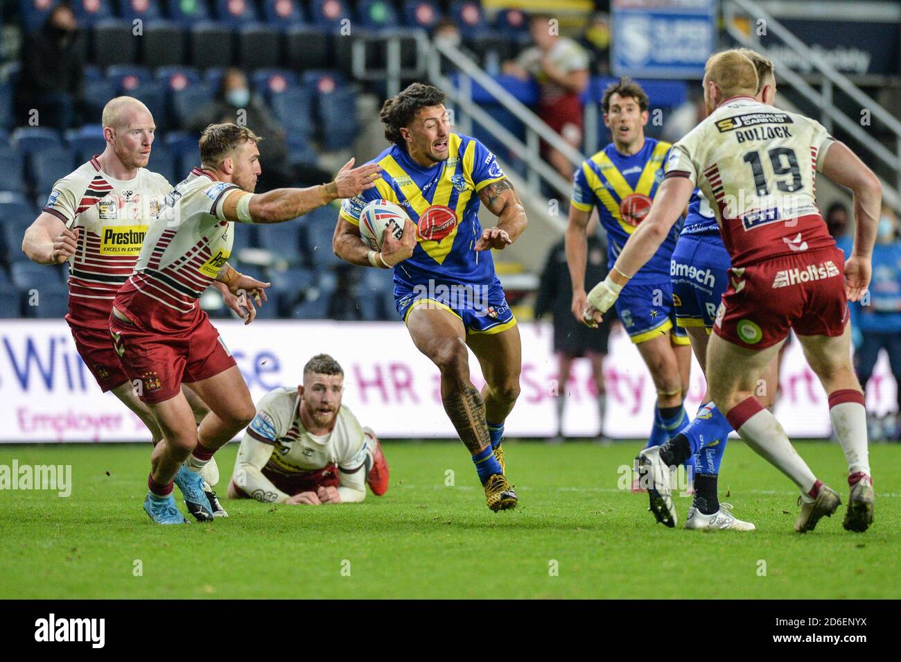 Anthony Gelling of Warrington Wolves skips through Wigan Warriors line ...