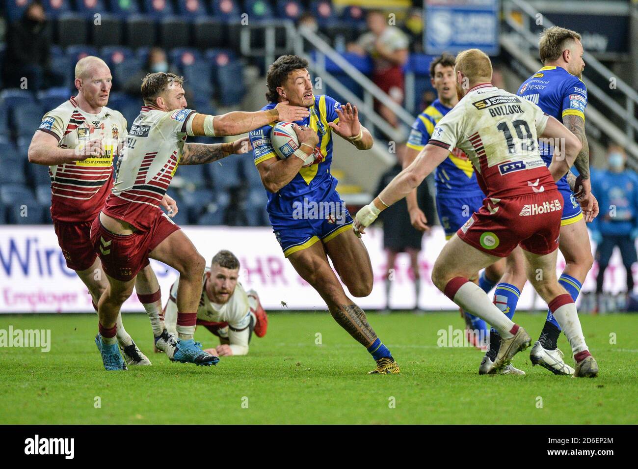 Anthony Gelling of Warrington Wolves skips through Wigan Warriors line ...