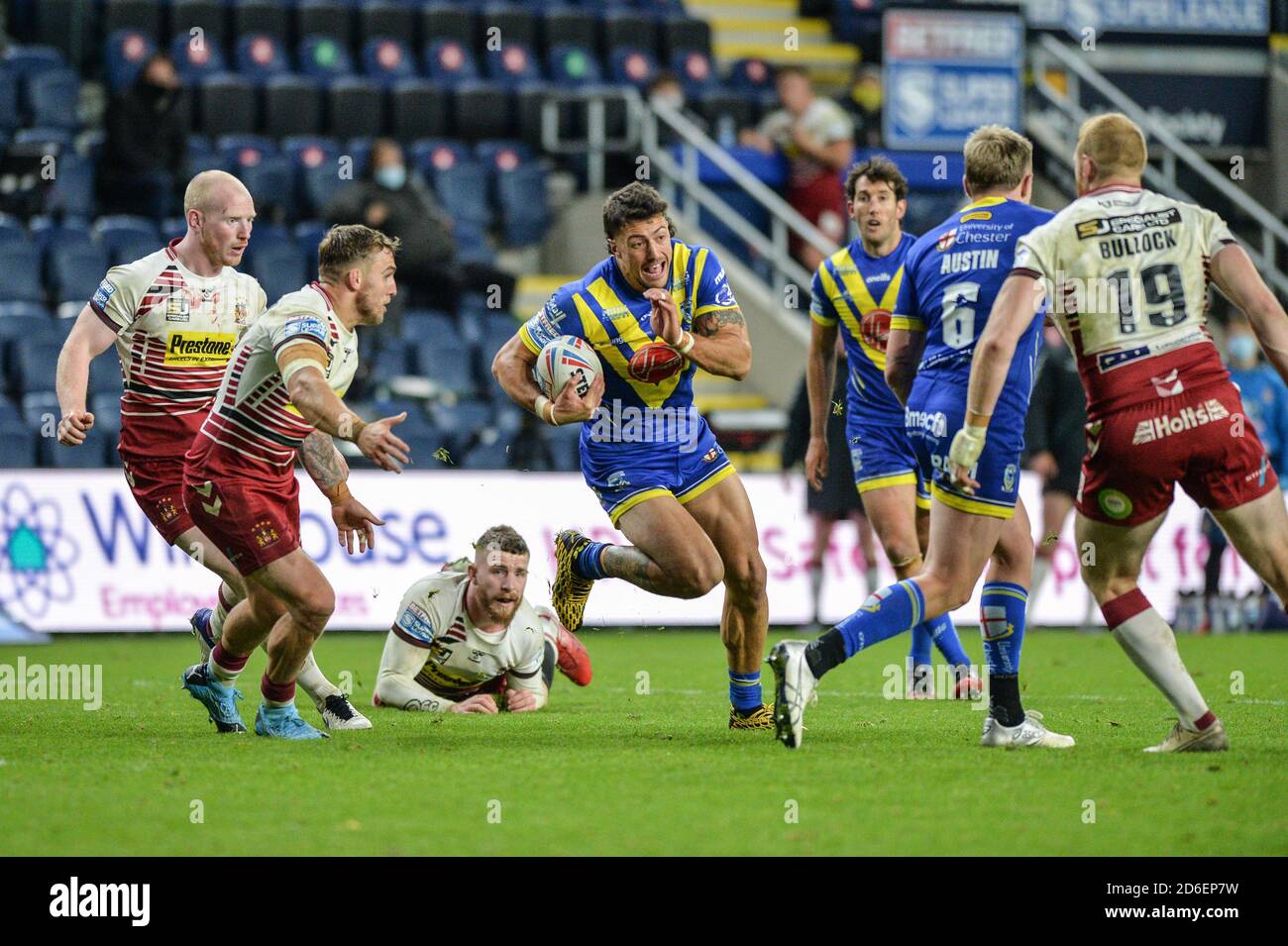 Anthony Gelling of Warrington Wolves skips through Wigan Warriors line ...