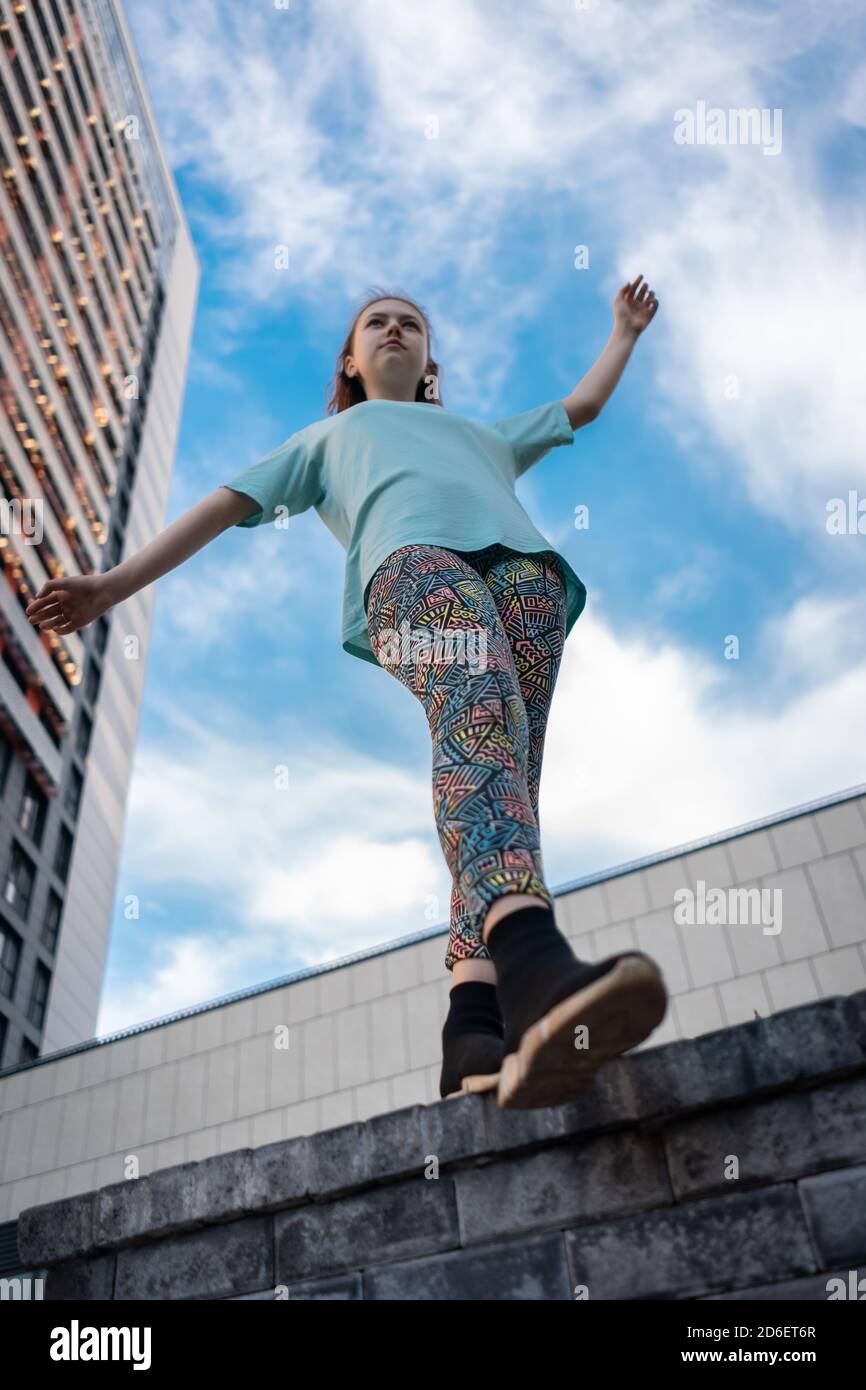 bottom view of stylish teenager near skyscraper walking outdoor Stock ...