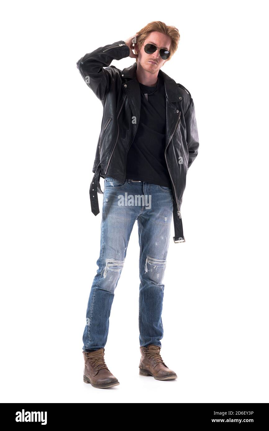 Suspicious uncertain young stylish rocker or biker looking at camera ...