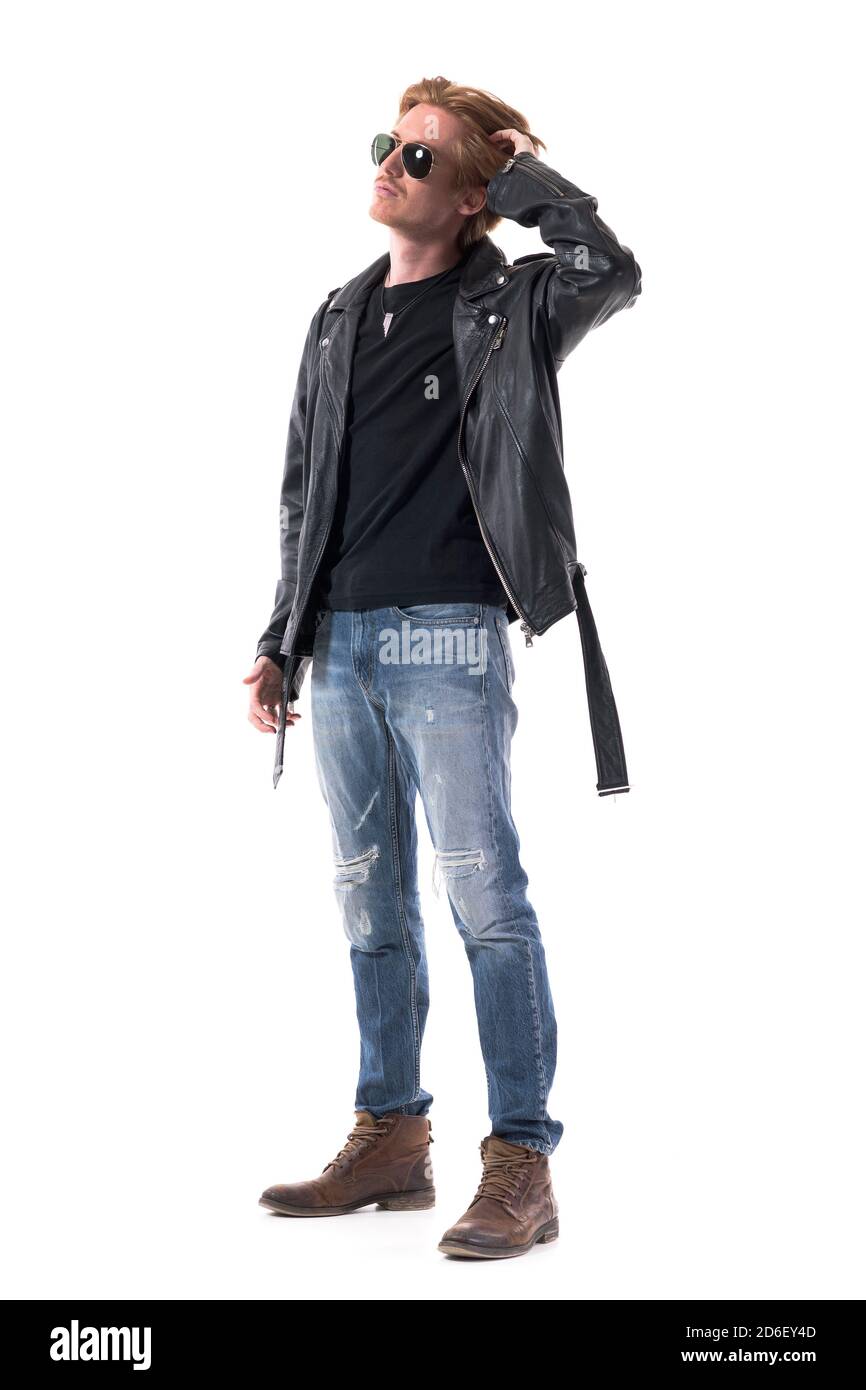 Thoughtful stylish rocker or biker looking up pondering and scratching ...