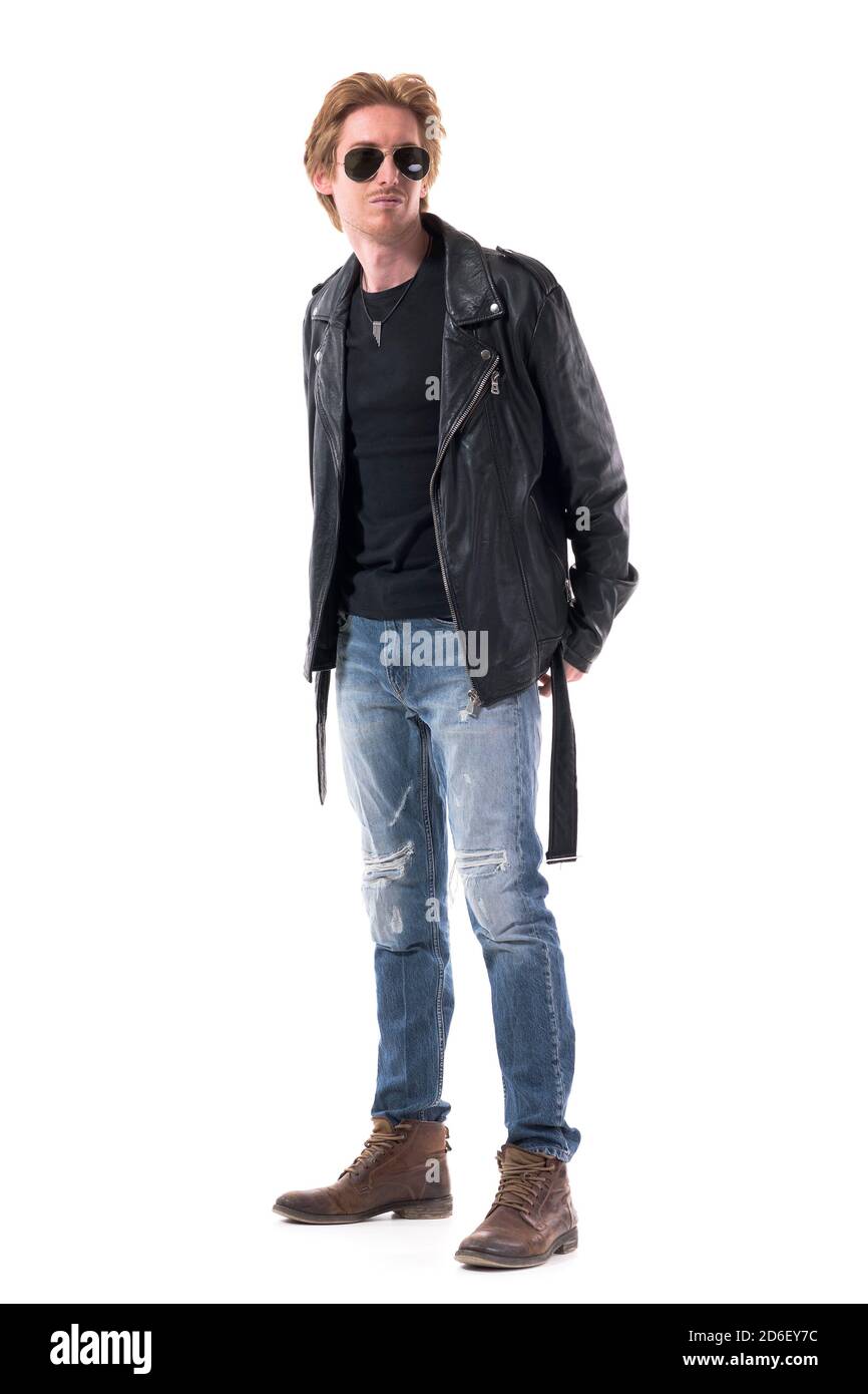 Side view of stylish masculine young redhead man in biker clothes with ...