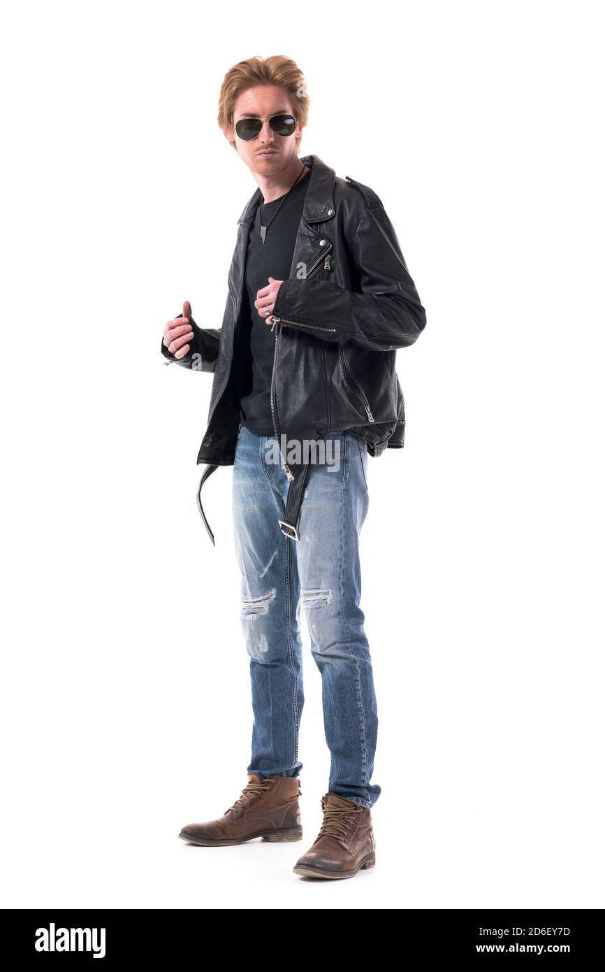 Side view of handsome biker in jeans and black leather jacket wearing ...