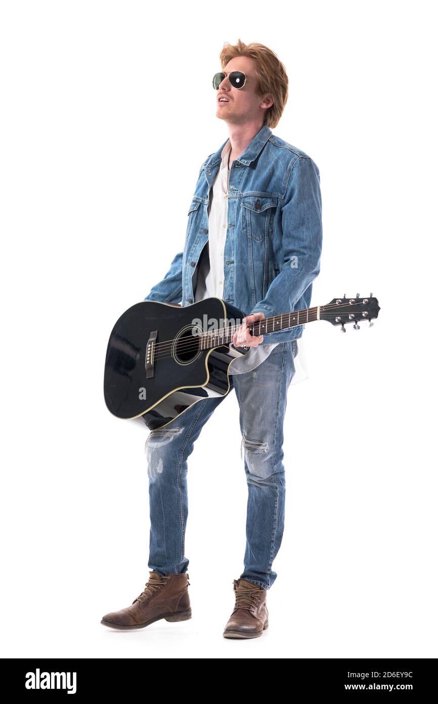 Male guitarist player in jeans with sunglasses relaxing looking up ...